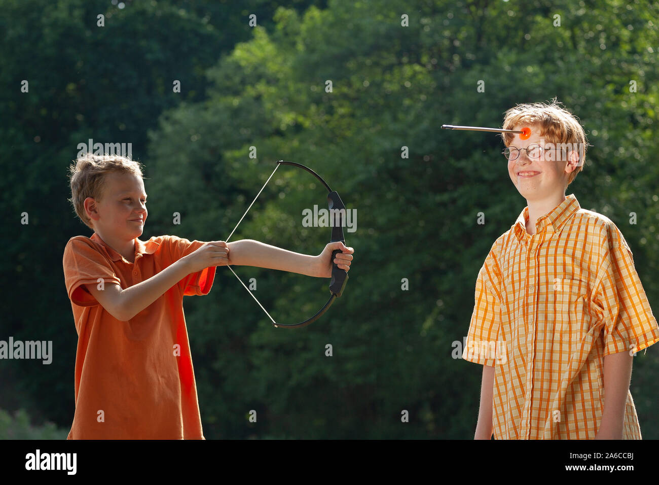 Boy playing with bow and arrow hi-res stock photography and images - Alamy