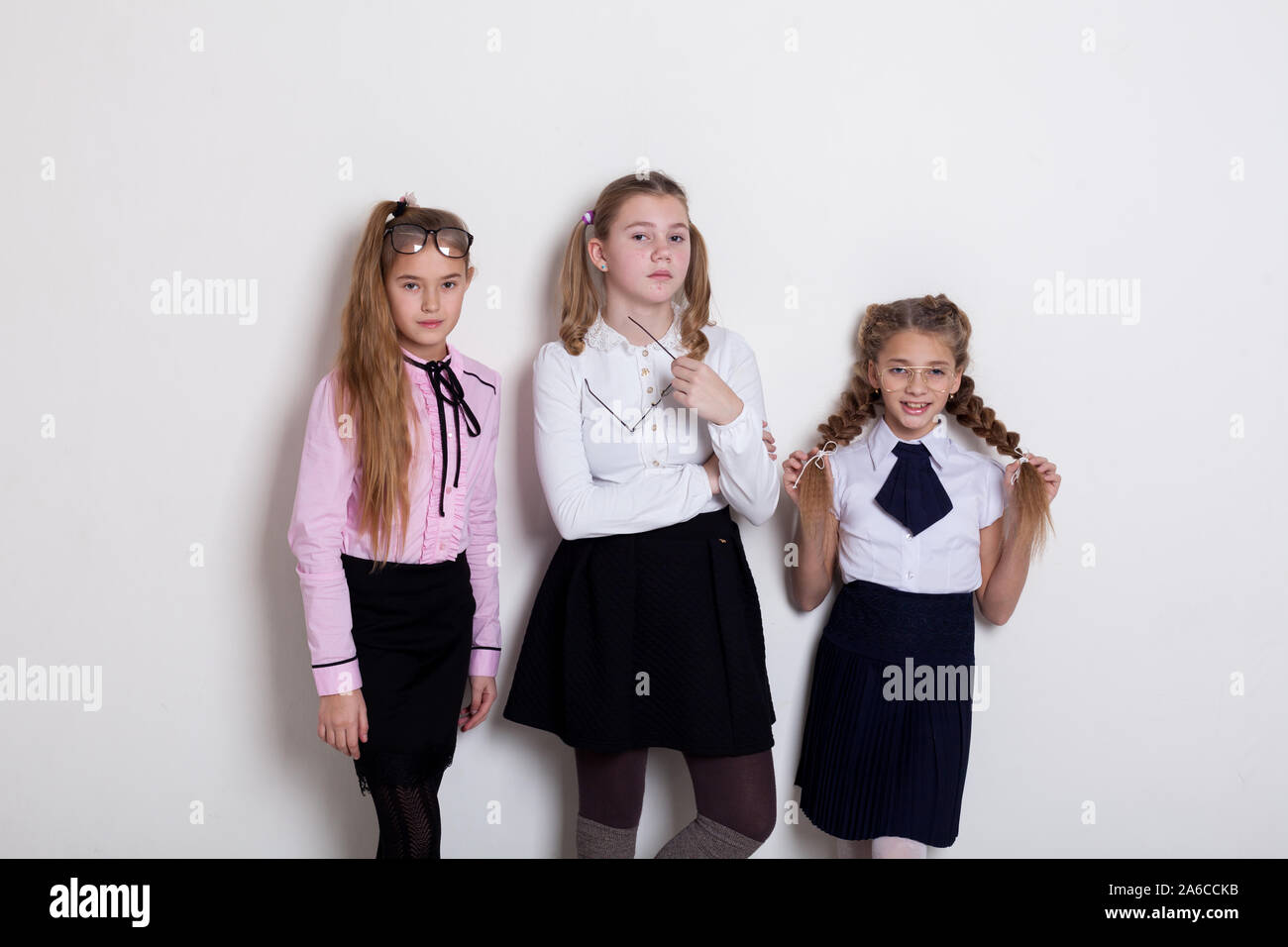 three schoolgirls in class at the school Stock Photo - Alamy
