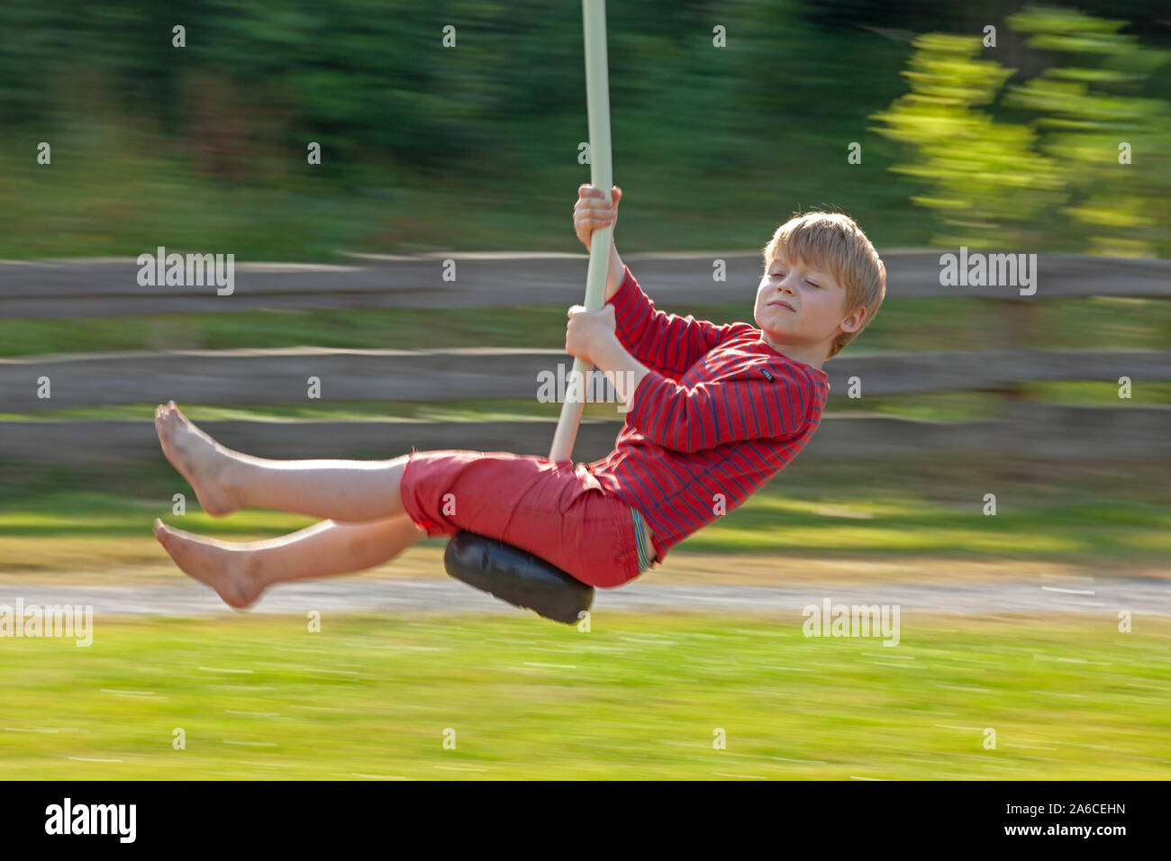 A young boy is enjoying a cable rope-ride Stock Photo - Alamy