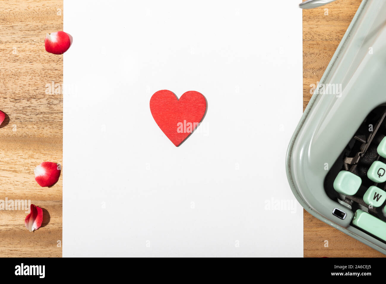 Love letter. Desk with blank paper, retro typewriter and red heart ...
