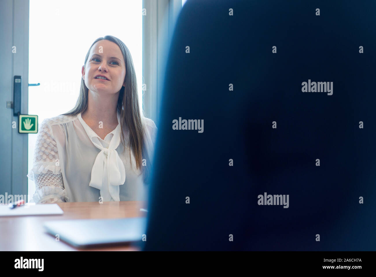 Women sit around a meeting table holding a productive meeting Stock ...