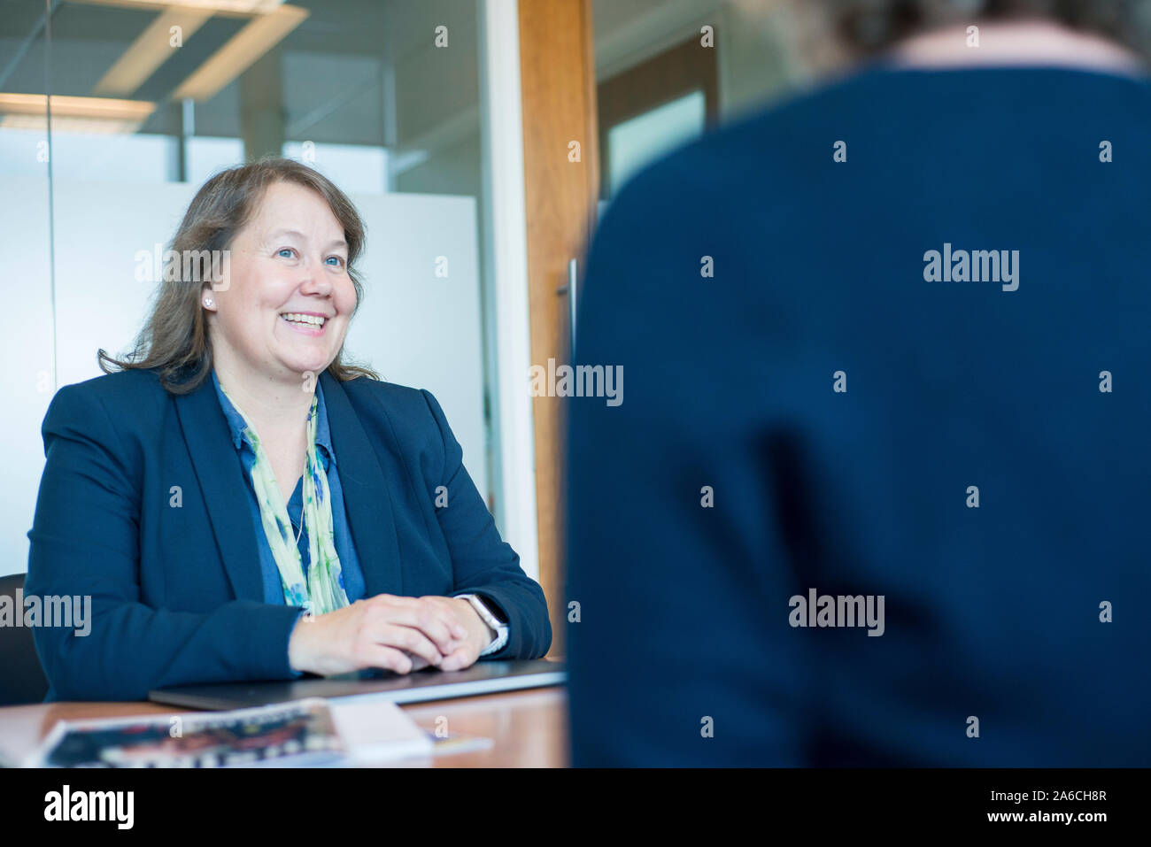 Women sit around a meeting table holding a productive meeting Stock ...