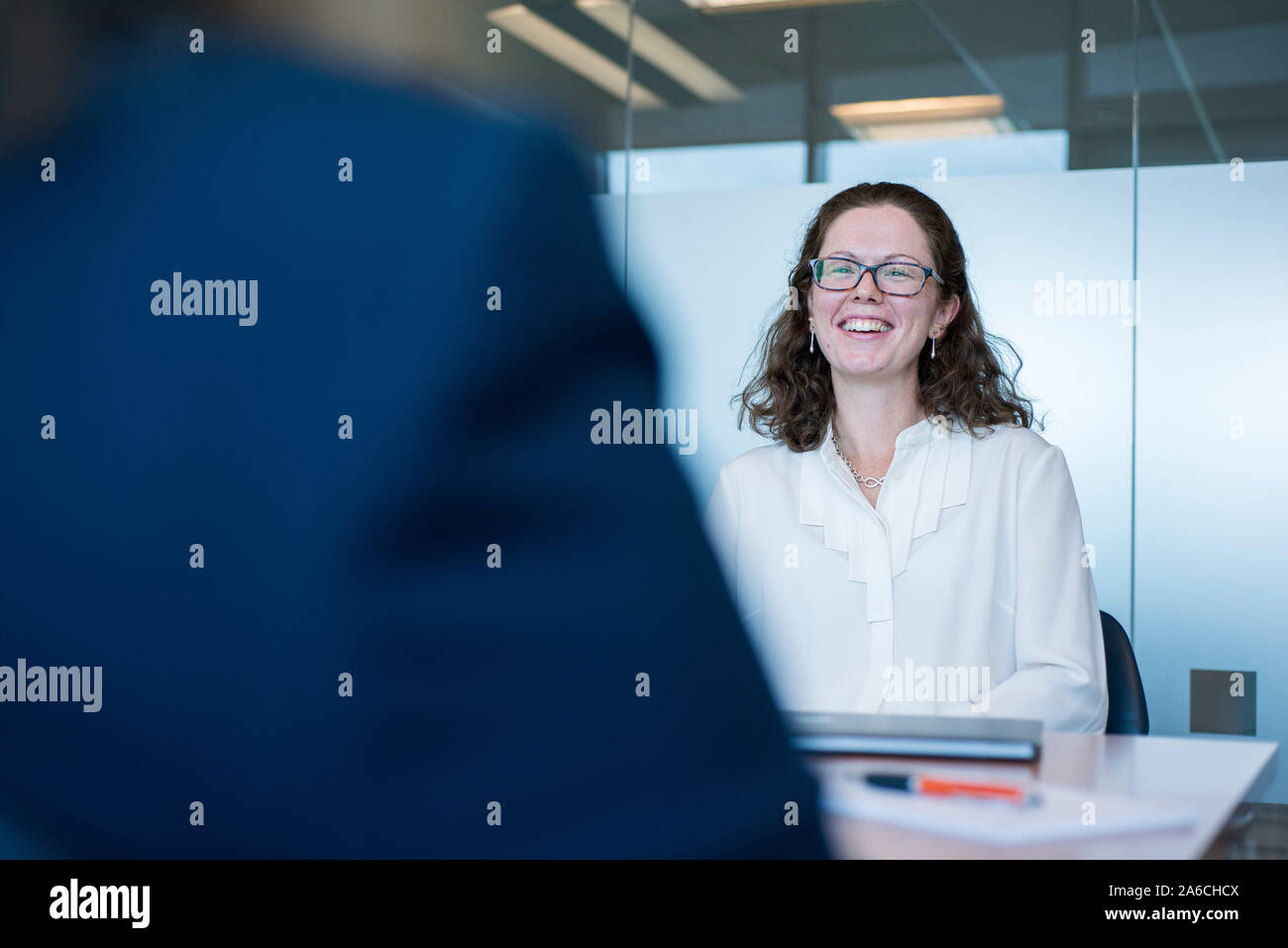 Women sit around a meeting table holding a productive meeting Stock ...
