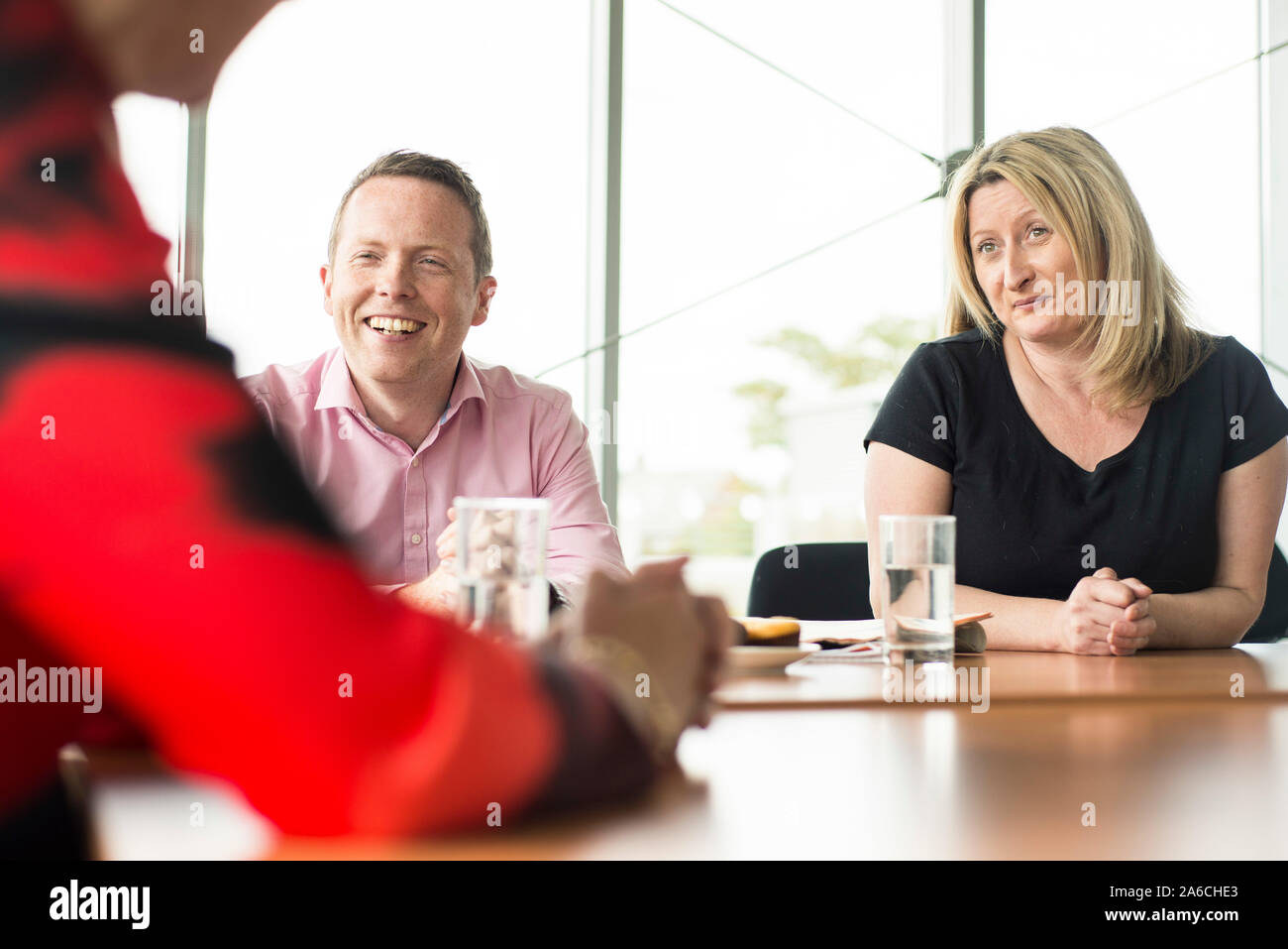 Women sit around a meeting table holding a productive meeting Stock ...