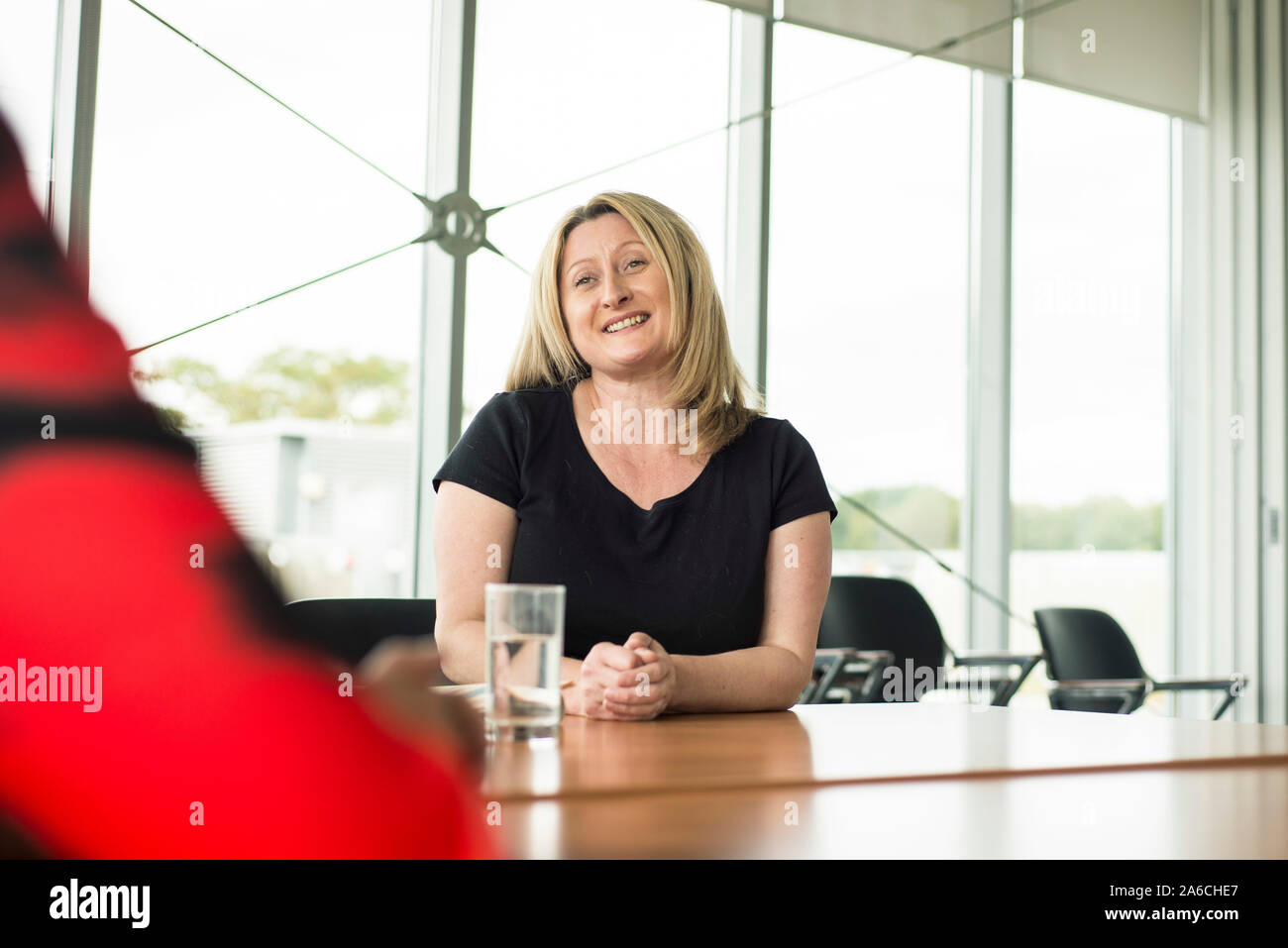 Women sit around a meeting table holding a productive meeting Stock ...