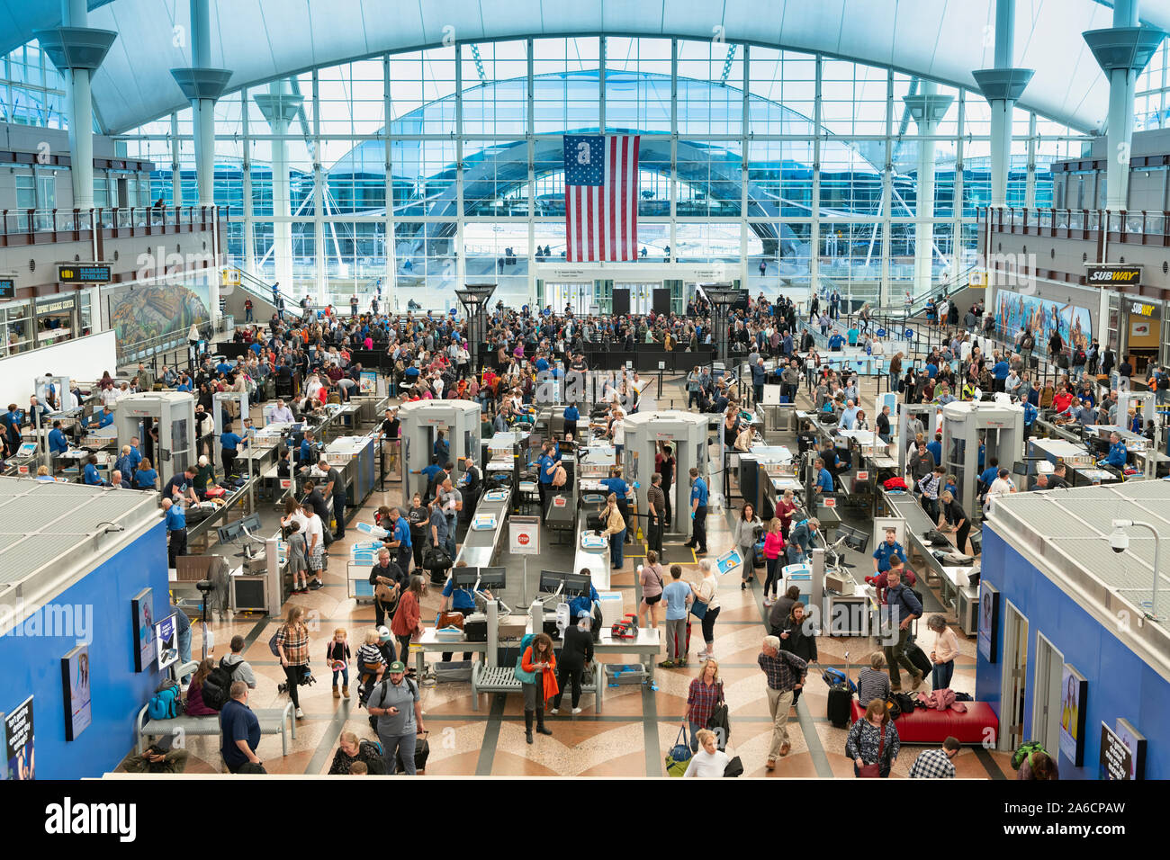 Crowd of travelers await TSA screening at Denver International Airport ...