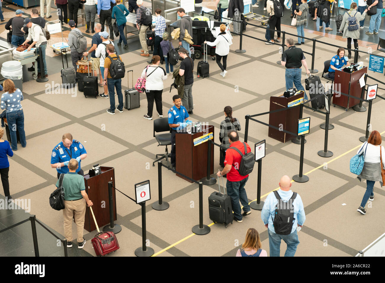 Crowd of travelers await TSA screening at Denver International Airport ...