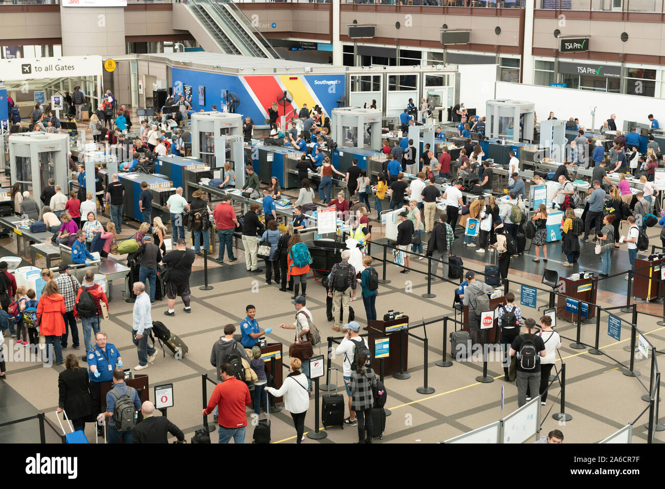 Crowd of travelers await TSA screening at Denver International Airport ...