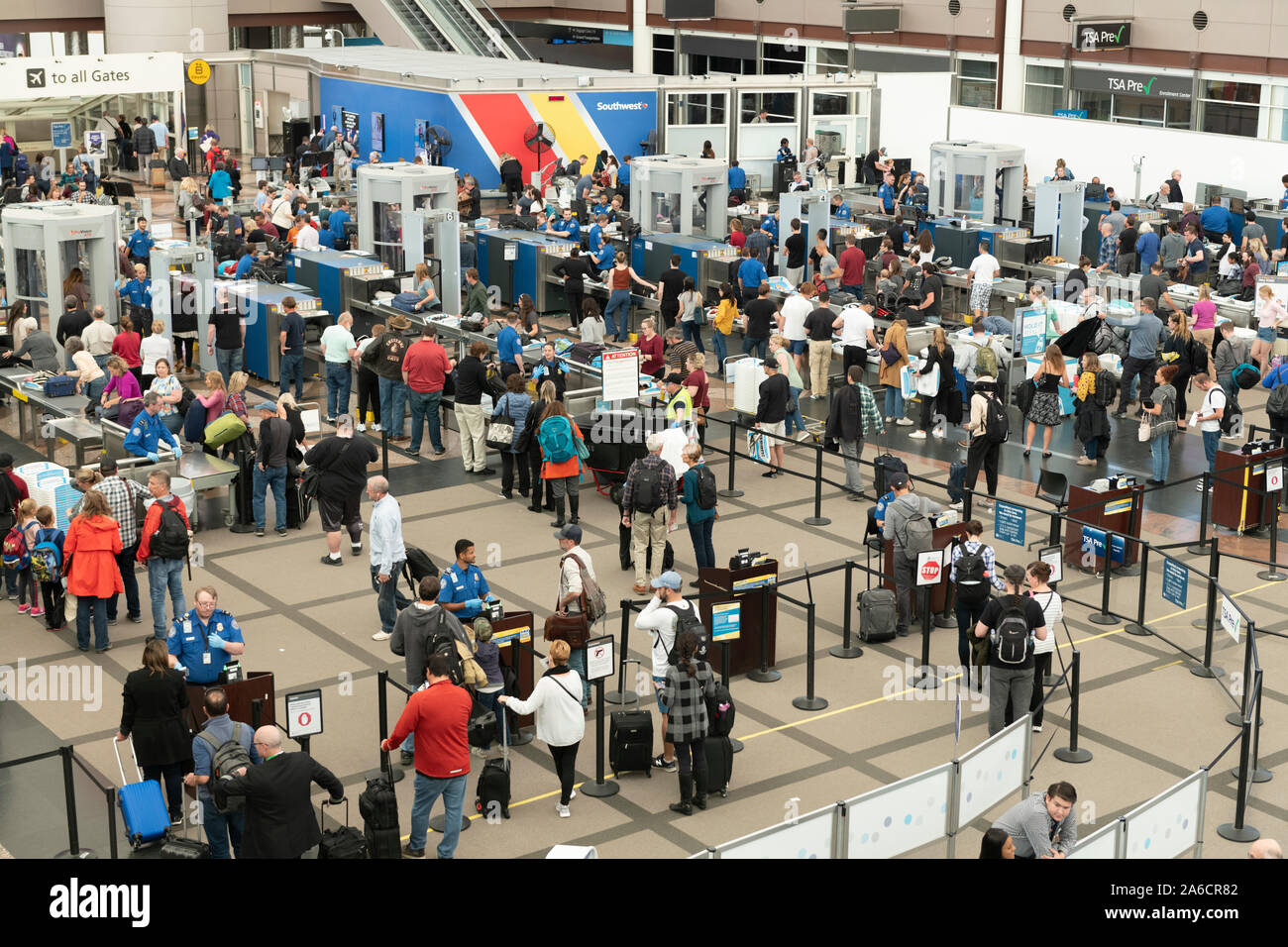 Crowd of travelers await TSA screening at Denver International Airport ...