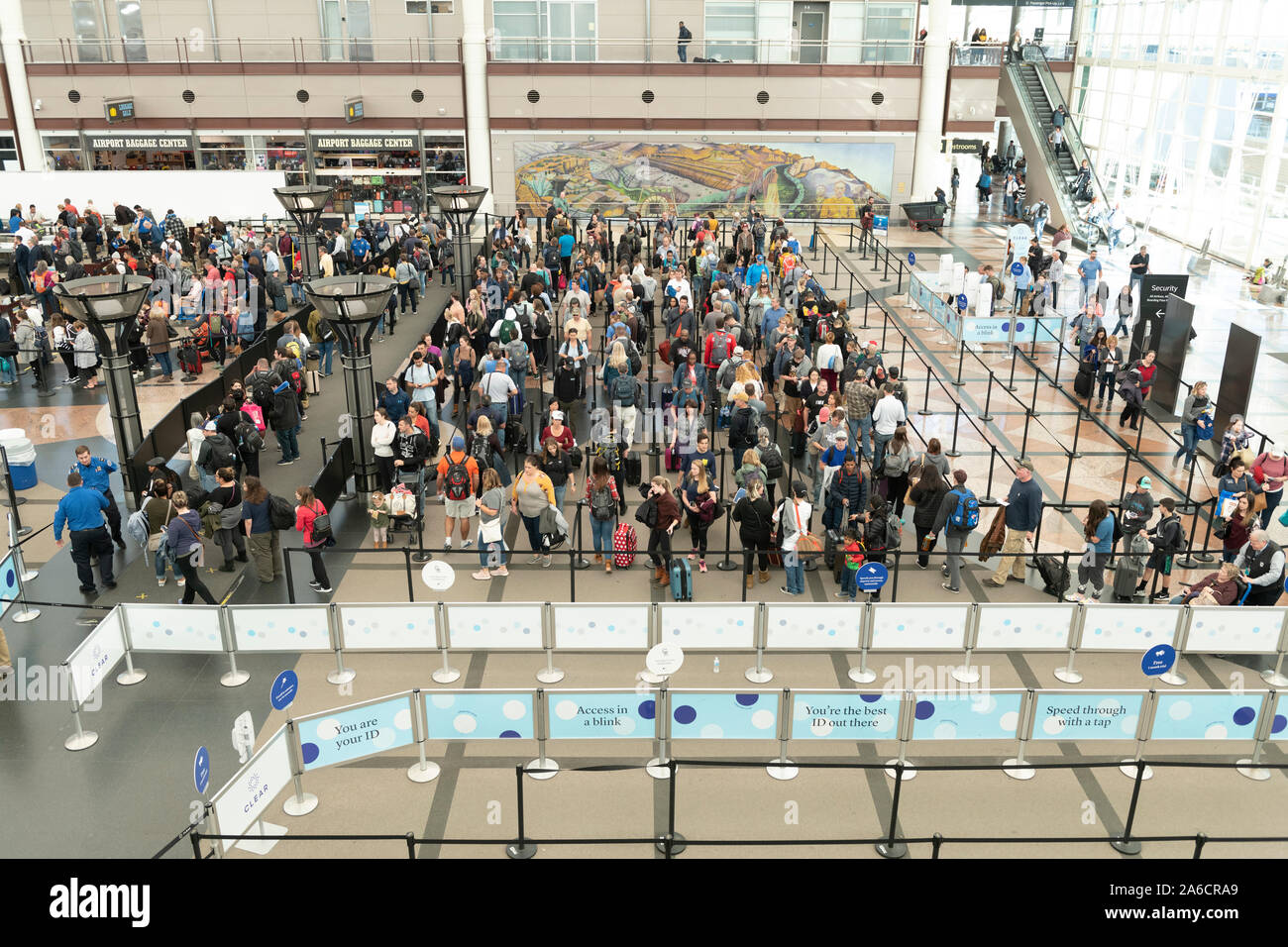 Crowd of travelers await TSA screening at Denver International Airport ...