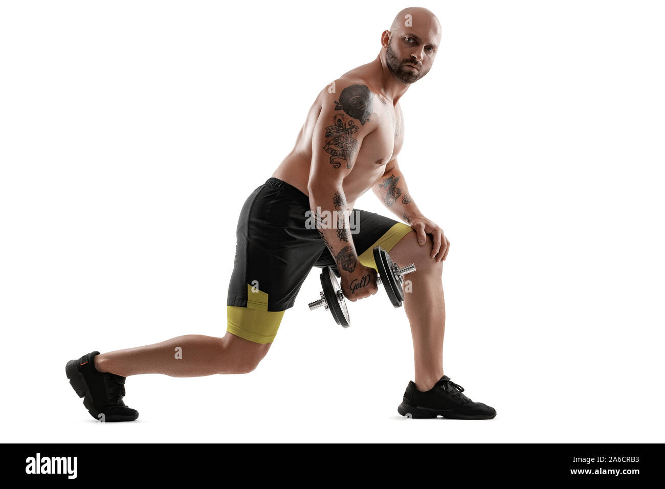 Stately bald, bearded, tattooed person in black shorts and sneakers is ...