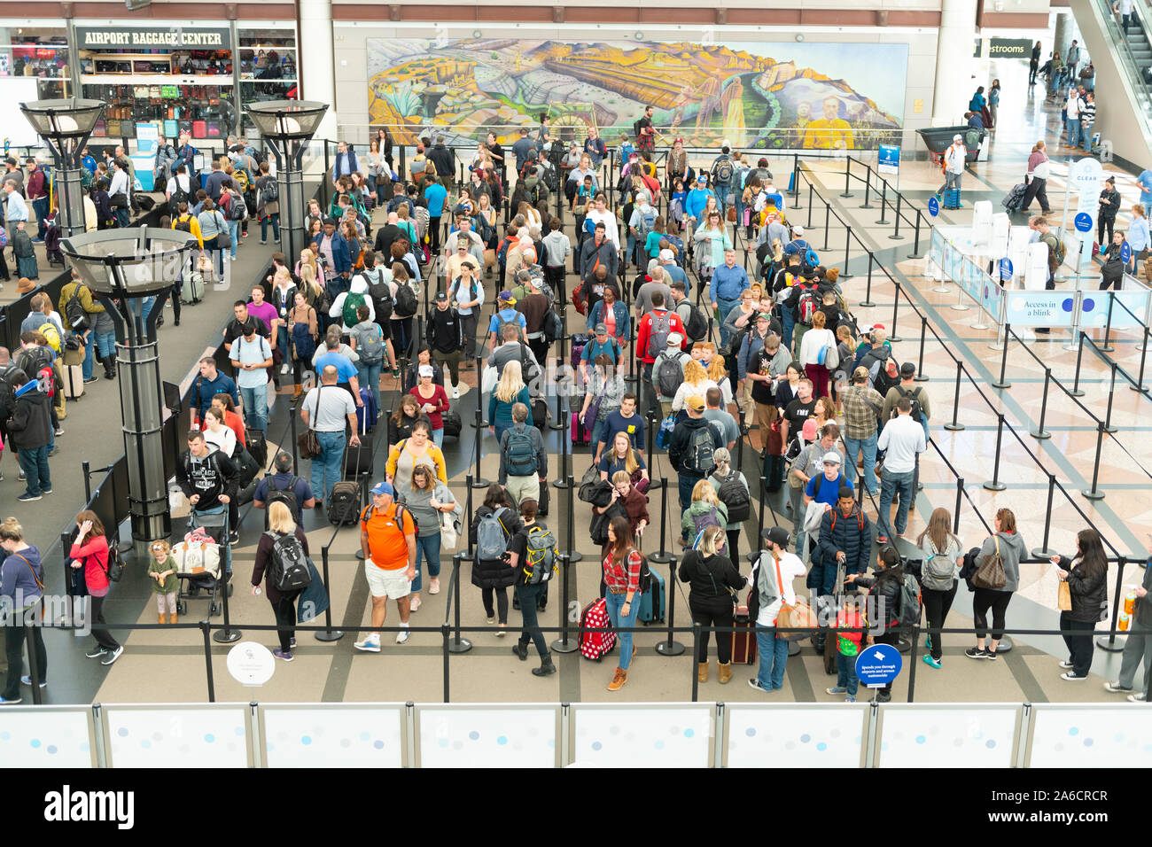 Crowd of travelers await TSA screening at Denver International Airport ...