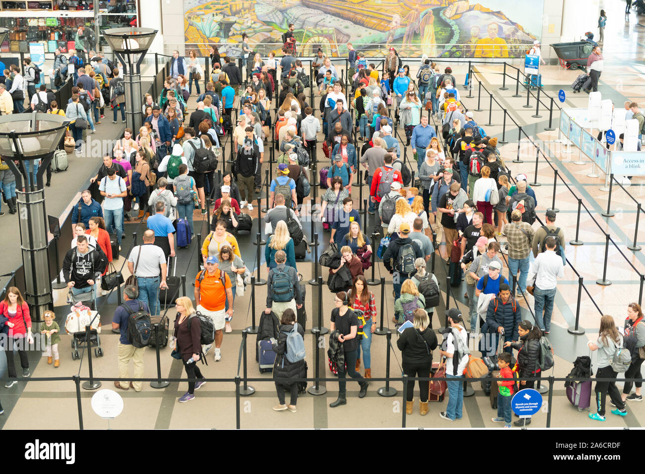 Crowd of travelers await TSA screening at Denver International Airport ...