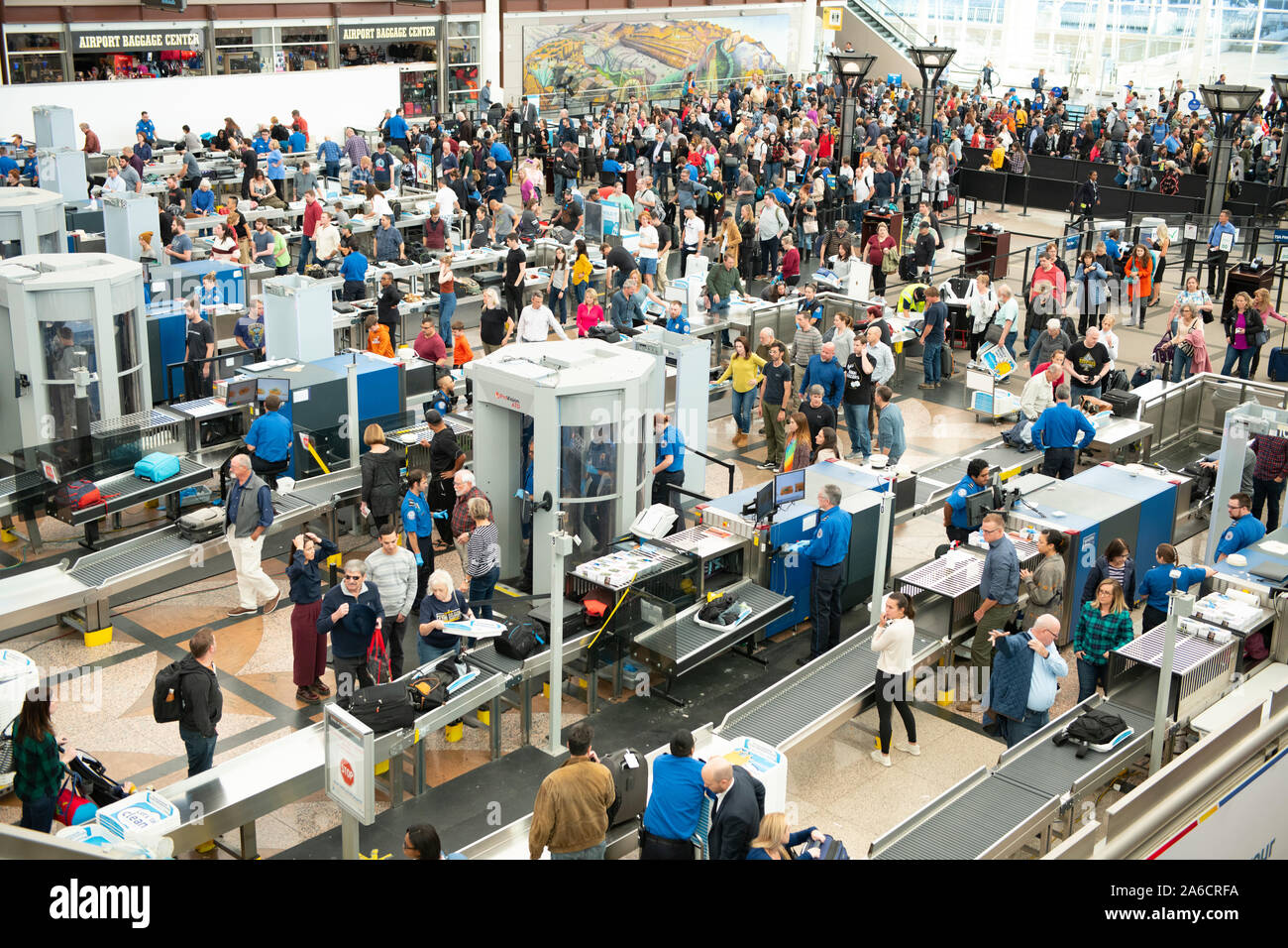 Crowd of travelers await TSA screening at Denver International Airport ...