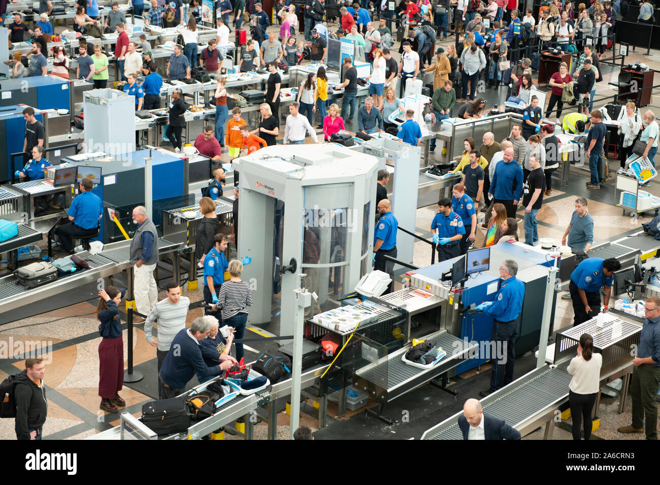 Crowd of travelers await TSA screening at Denver International Airport ...