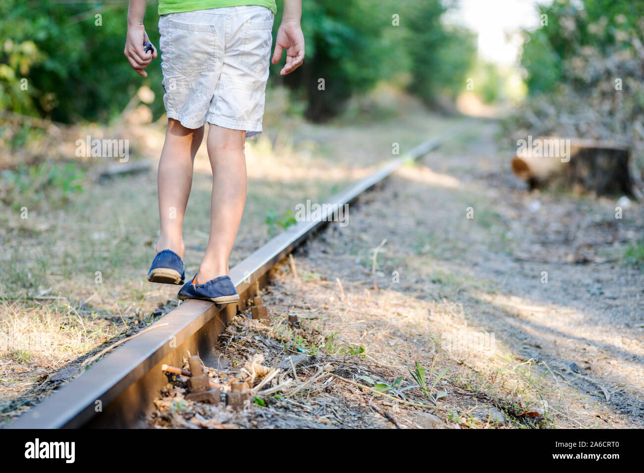 The child walking on the railway. A small boy walk on the railway a ...