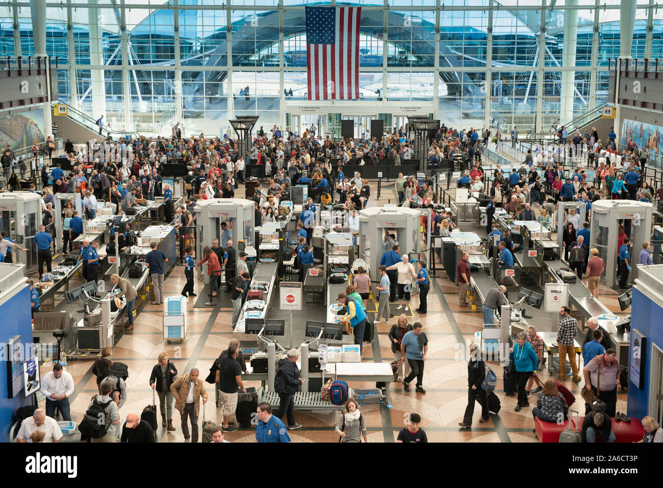 Crowd of travelers await TSA screening at Denver International Airport ...