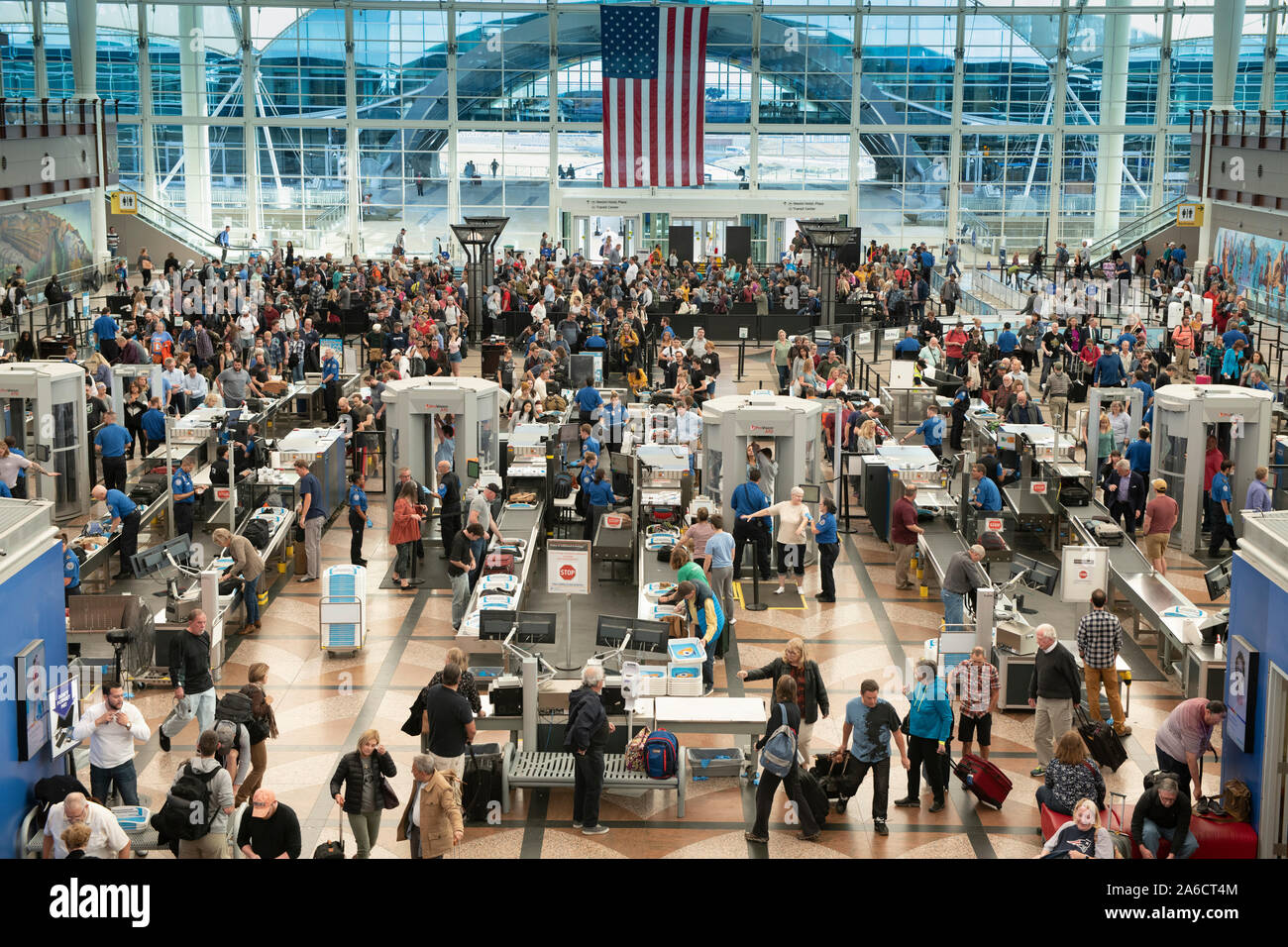 Crowd of travelers await TSA screening at Denver International Airport ...