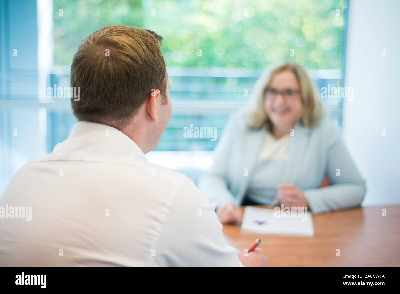 two people sat at a table having a meeting or a job interview Stock ...