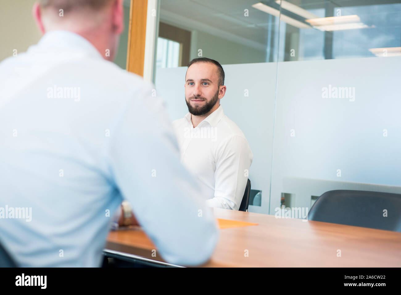 two people sat at a table having a meeting or a job interview Stock ...