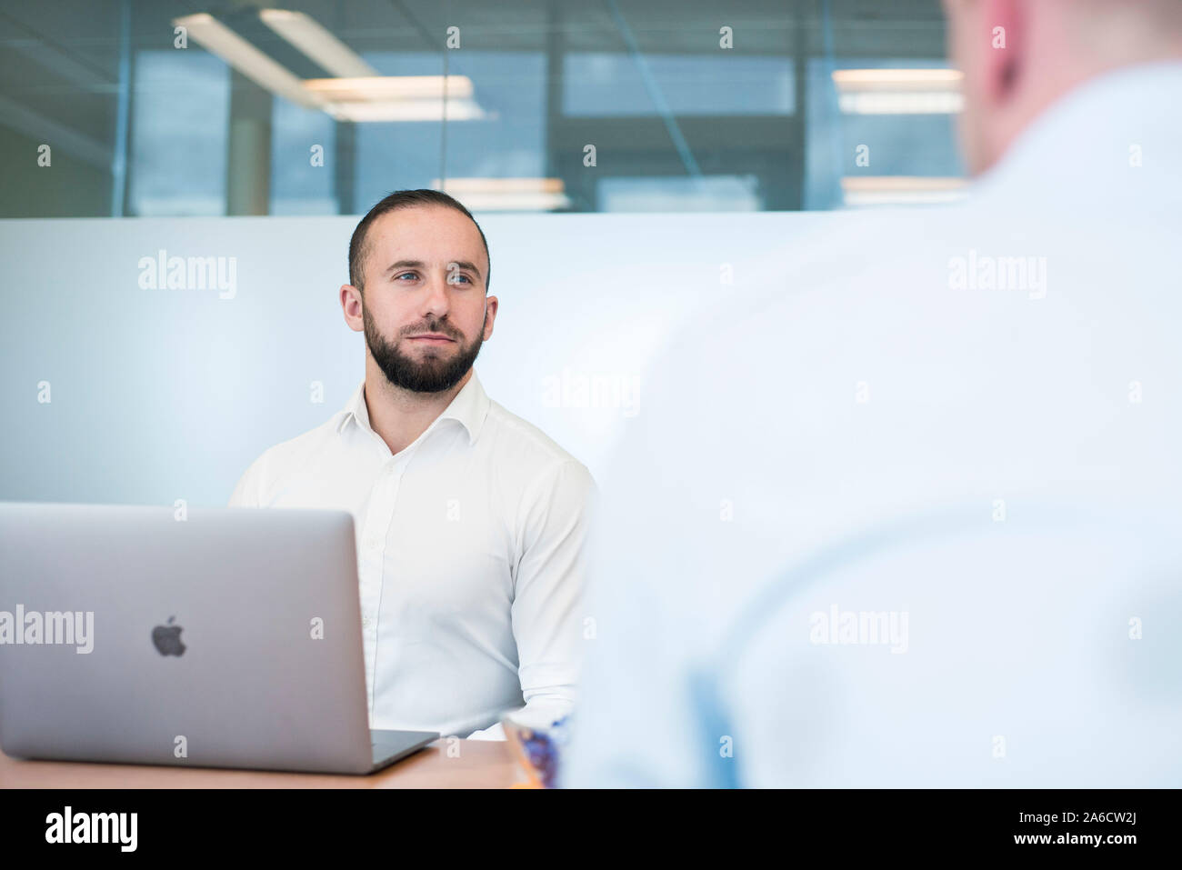 two people sat at a table having a meeting or a job interview Stock ...