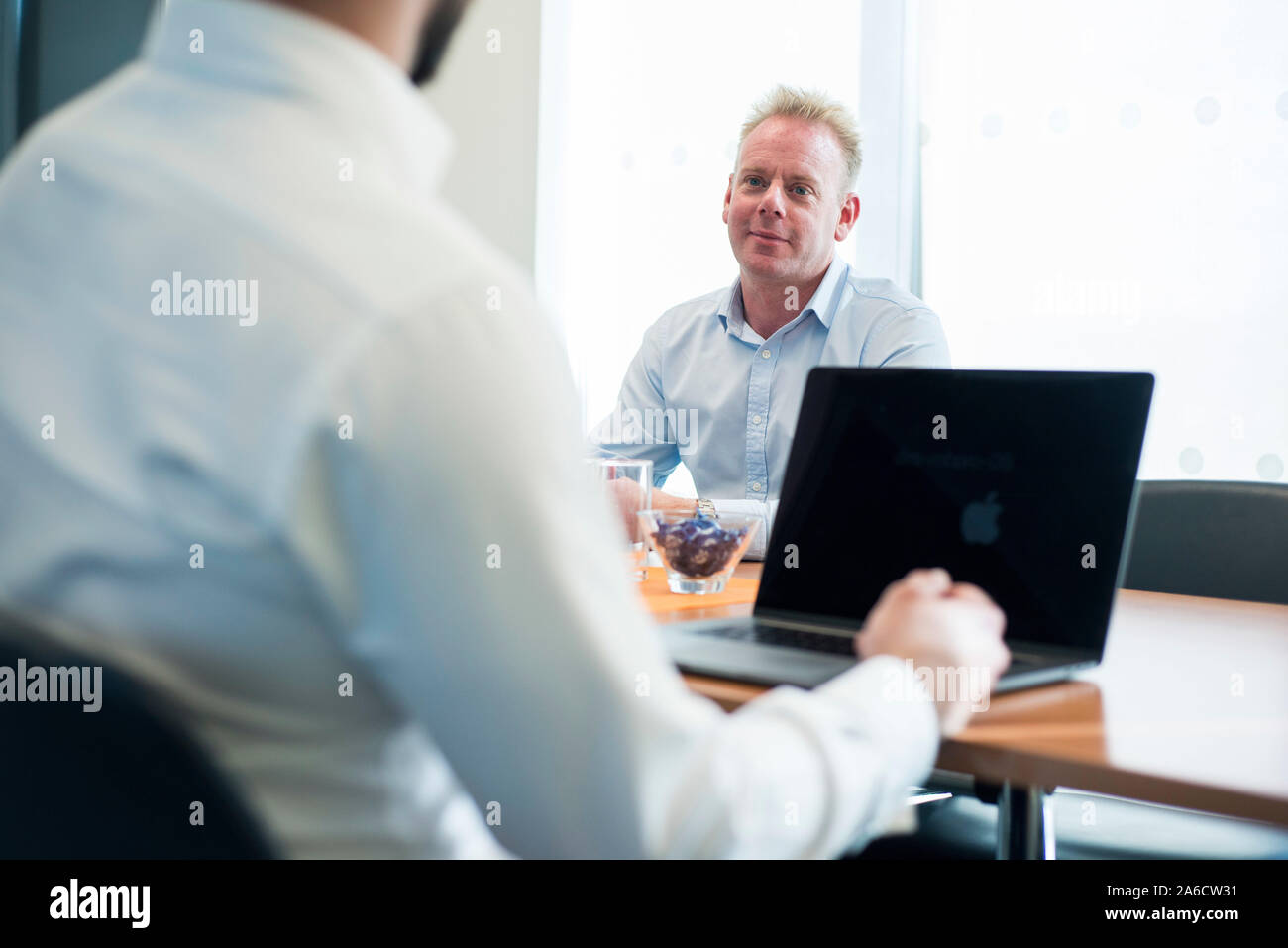 two people sat at a table having a meeting or a job interview Stock ...