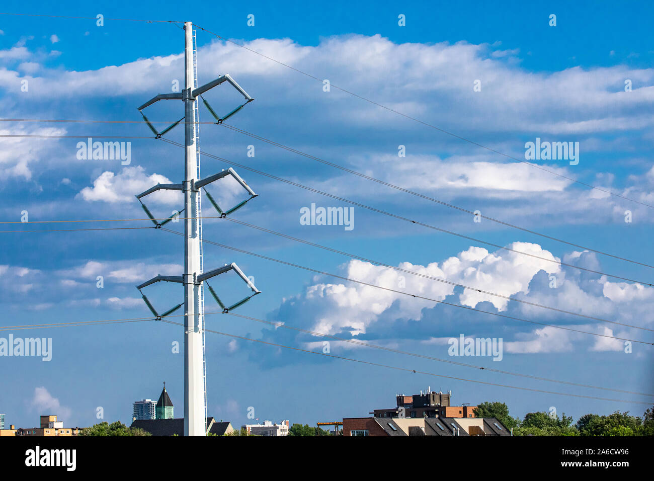A closeup view of a white electric pylon supporting overhead power ...