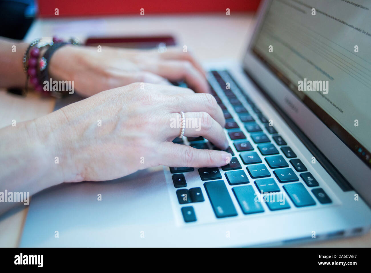 Female hands typing on a lap top keyboard Stock Photo - Alamy