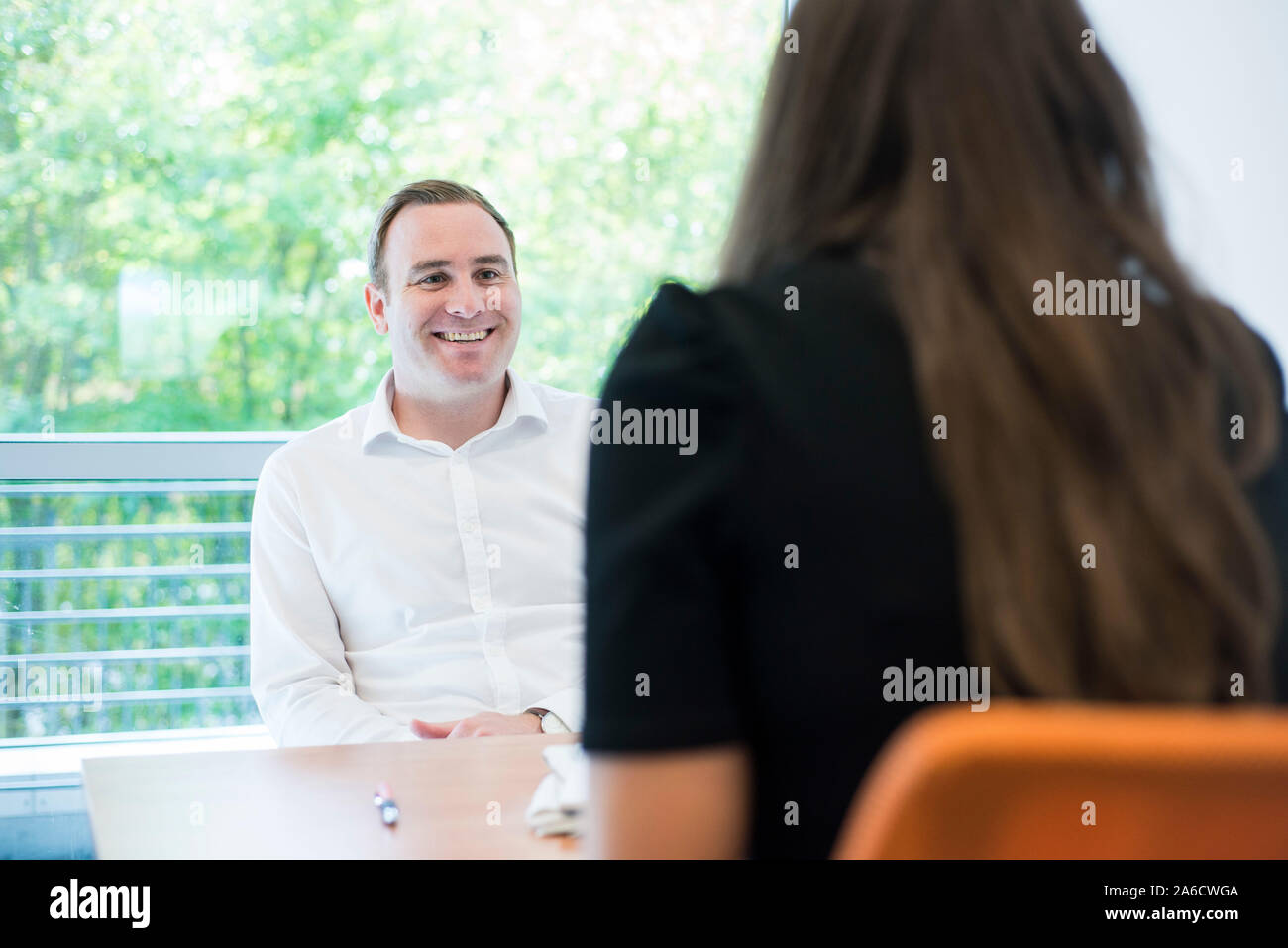 two people sat at a table having a meeting or a job interview Stock ...