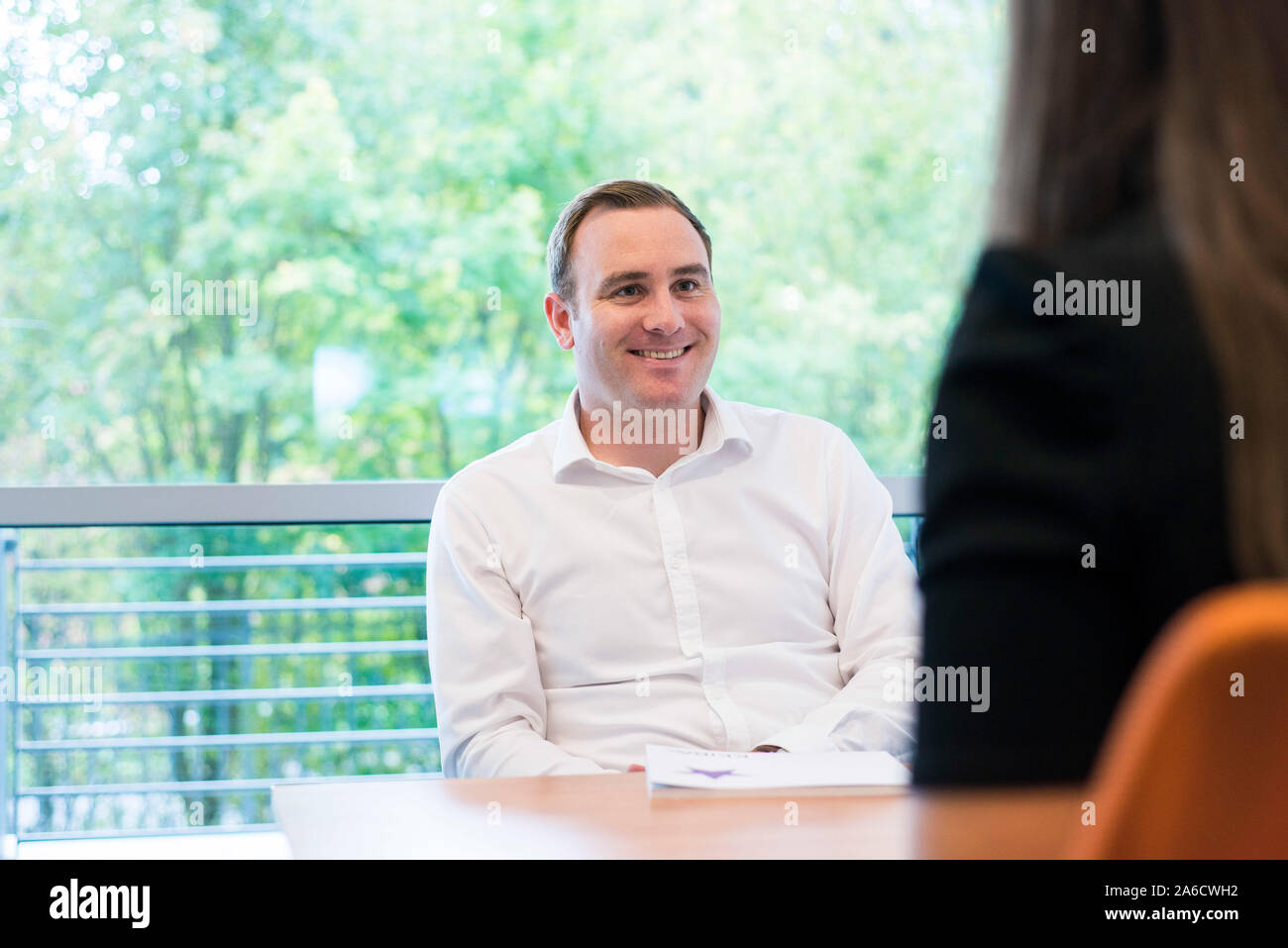 two people sat at a table having a meeting or a job interview Stock ...
