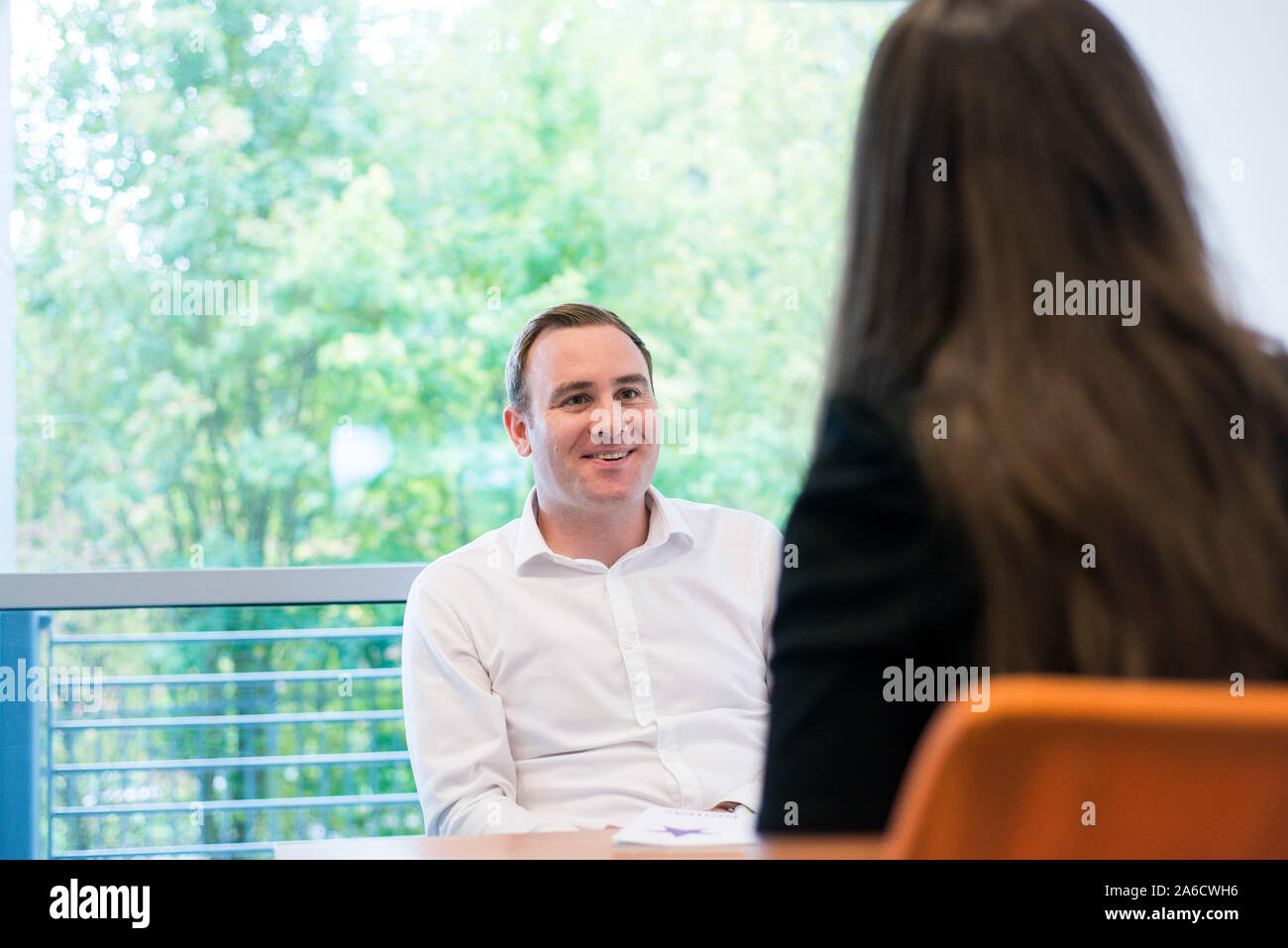 two people sat at a table having a meeting or a job interview Stock ...