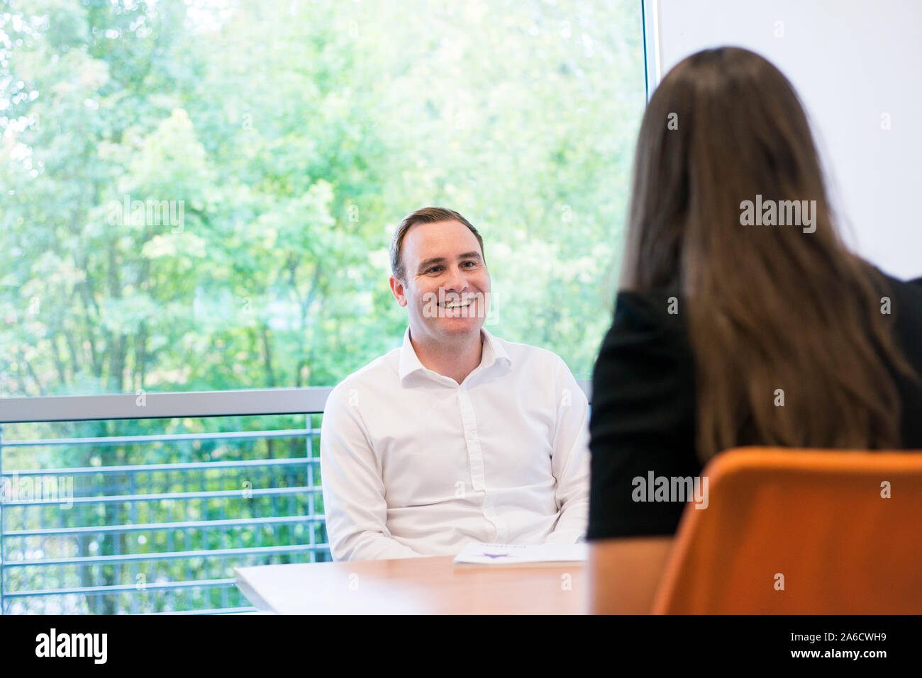 two people sat at a table having a meeting or a job interview Stock ...