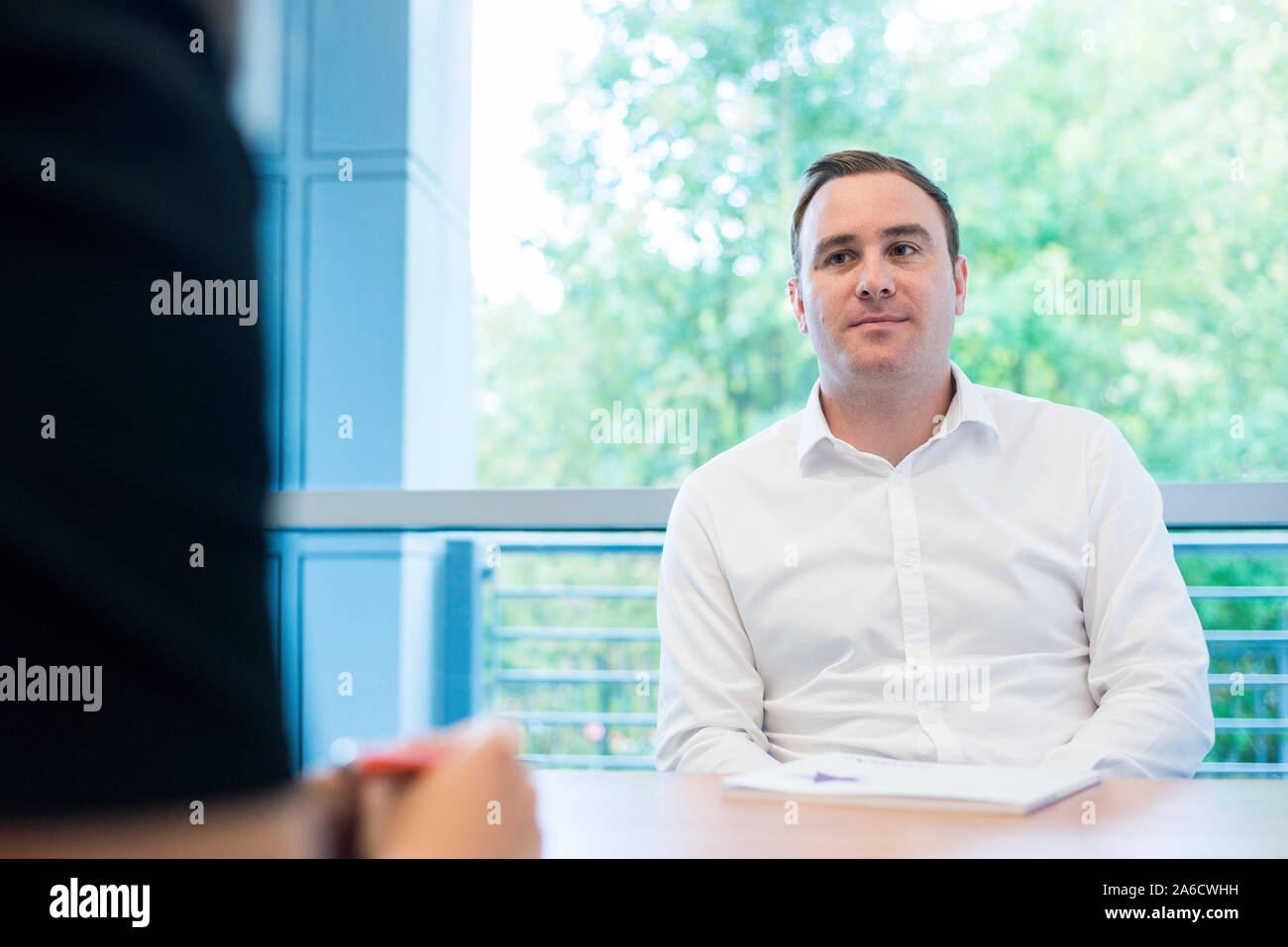 two people sat at a table having a meeting or a job interview Stock ...