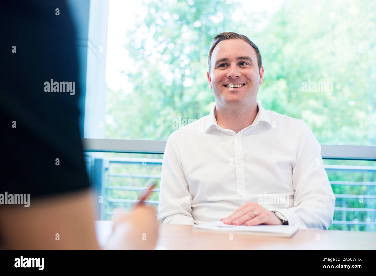 two people sat at a table having a meeting or a job interview Stock ...