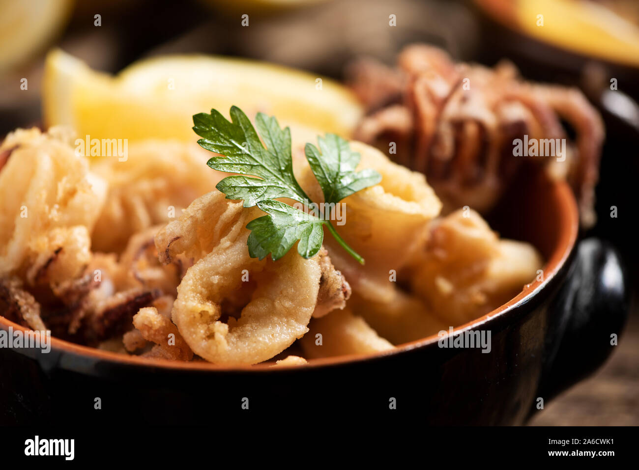 Traditional Italian fried calamari and lemon slice close up Stock Photo ...
