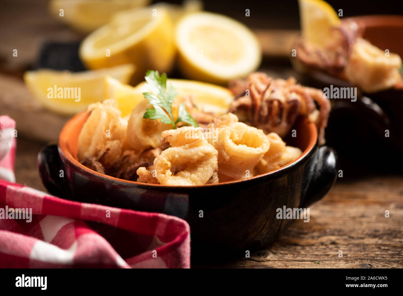 Traditional Italian fried calamari and lemon slice close up Stock Photo ...