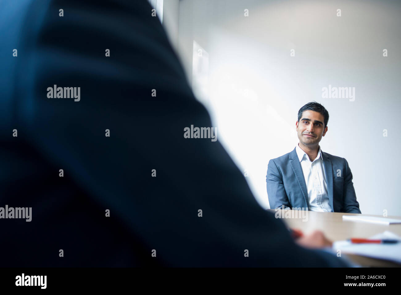 two people sat at a table having a meeting or a job interview Stock ...