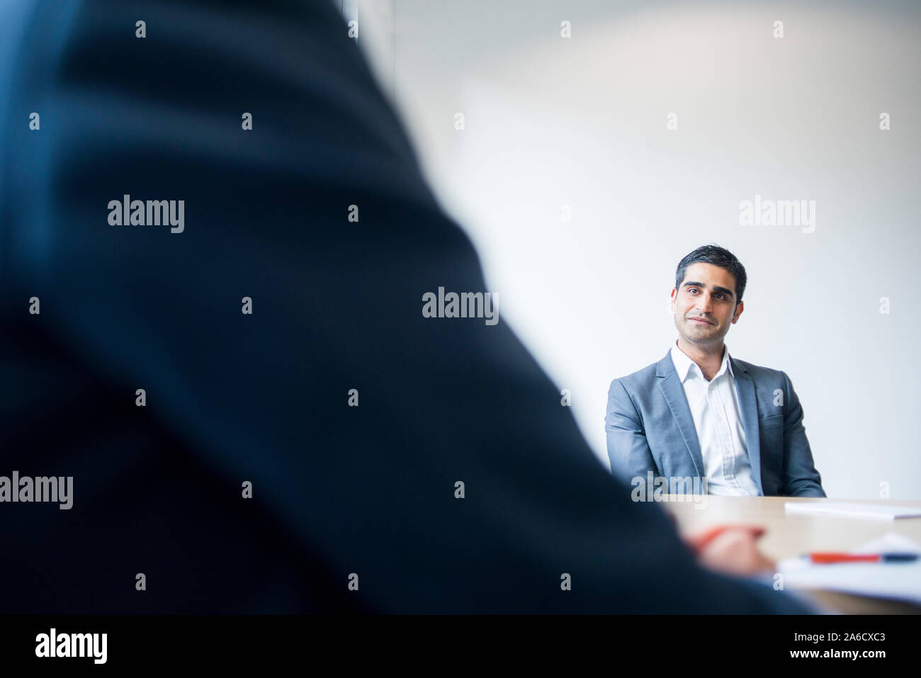 two people sat at a table having a meeting or a job interview Stock ...