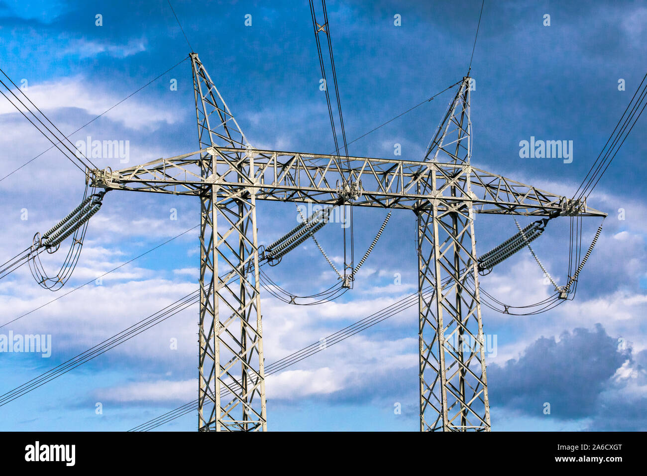 A low angle view of a truss style transmission tower supporting high ...