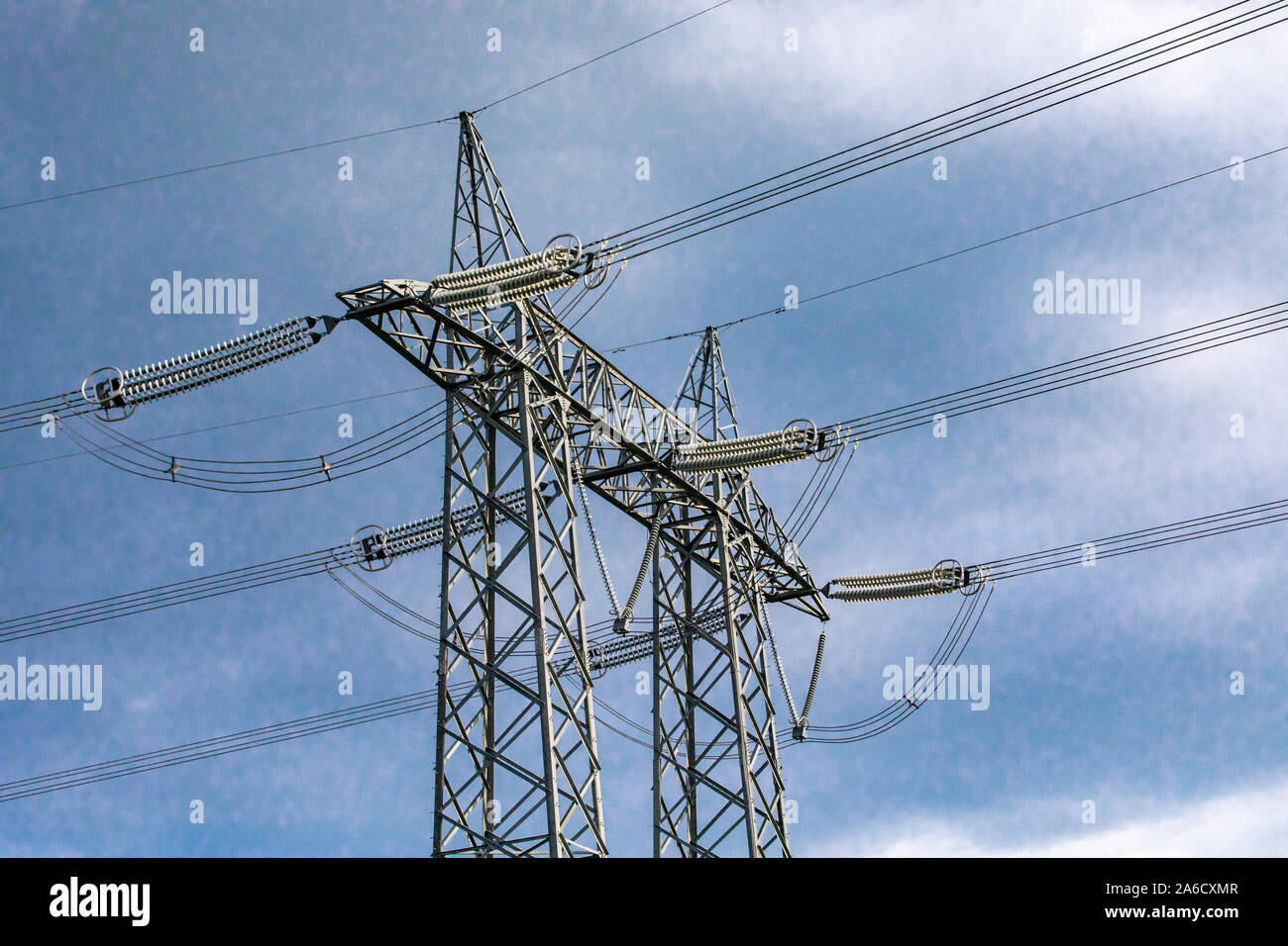 A low angle and off to the side view of a tall electric pylon, steel ...