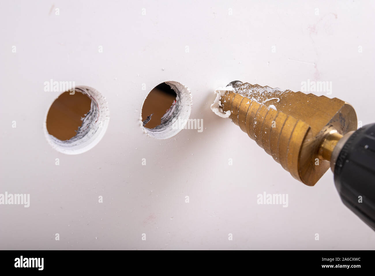 Conical drill used for small housework. Drilling in plastic with tool ...
