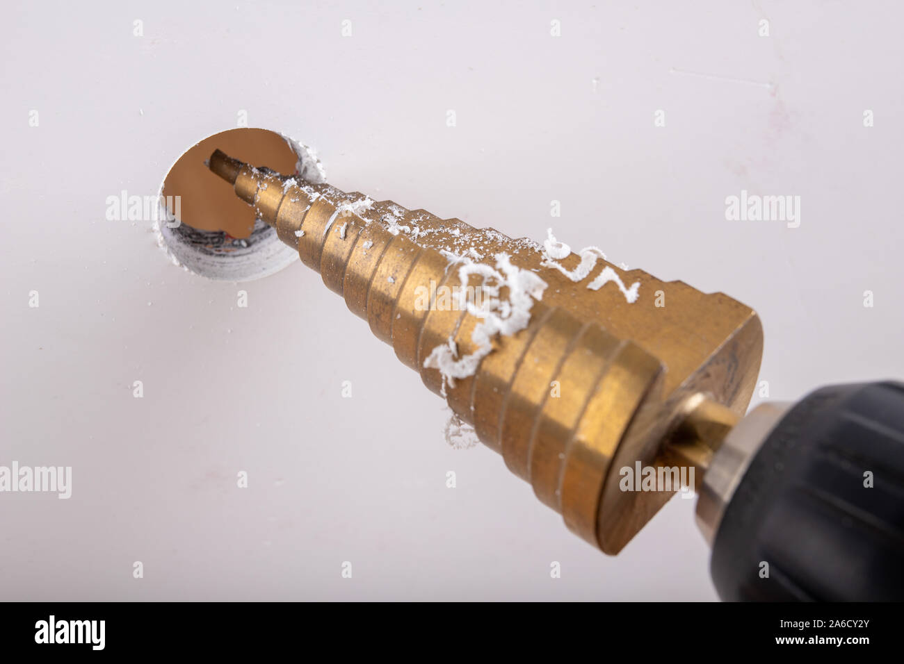 Conical drill used for small housework. Drilling in plastic with tool ...