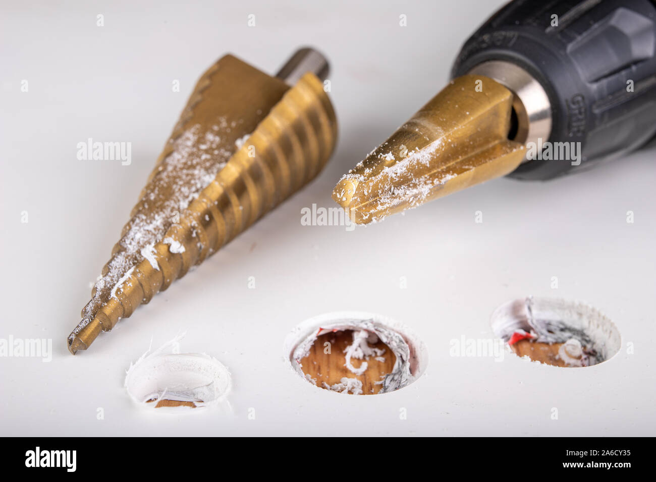 Conical drill used for small housework. Drilling in plastic with tool ...