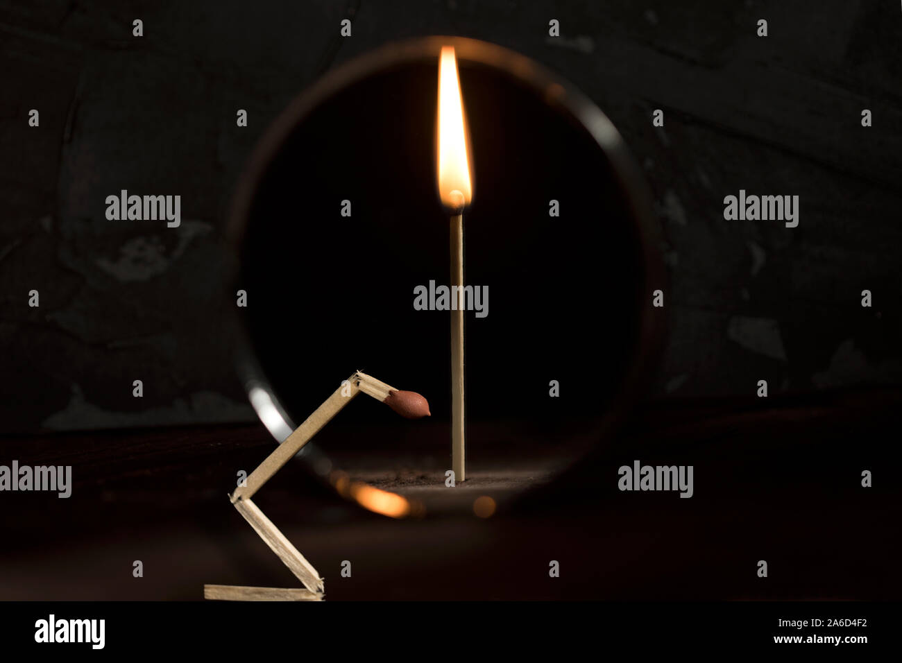 Broken match is against the mirror and the reflection shows a whole ...