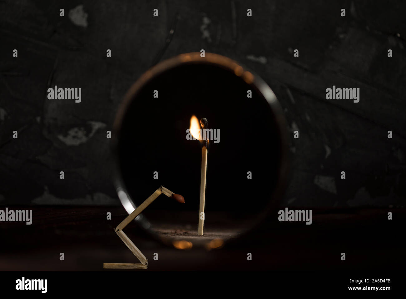 Broken match is against the mirror and the reflection shows a whole ...