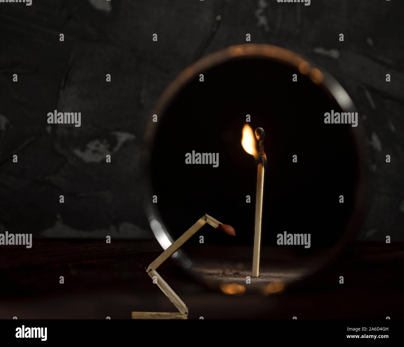 Broken match is against the mirror and the reflection shows a whole ...