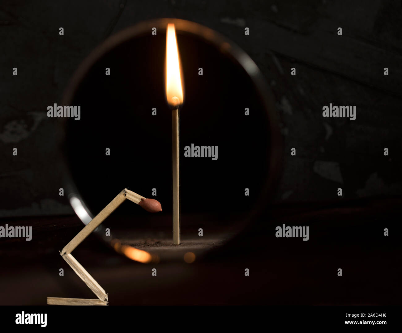 Broken match is against the mirror and the reflection shows a whole ...