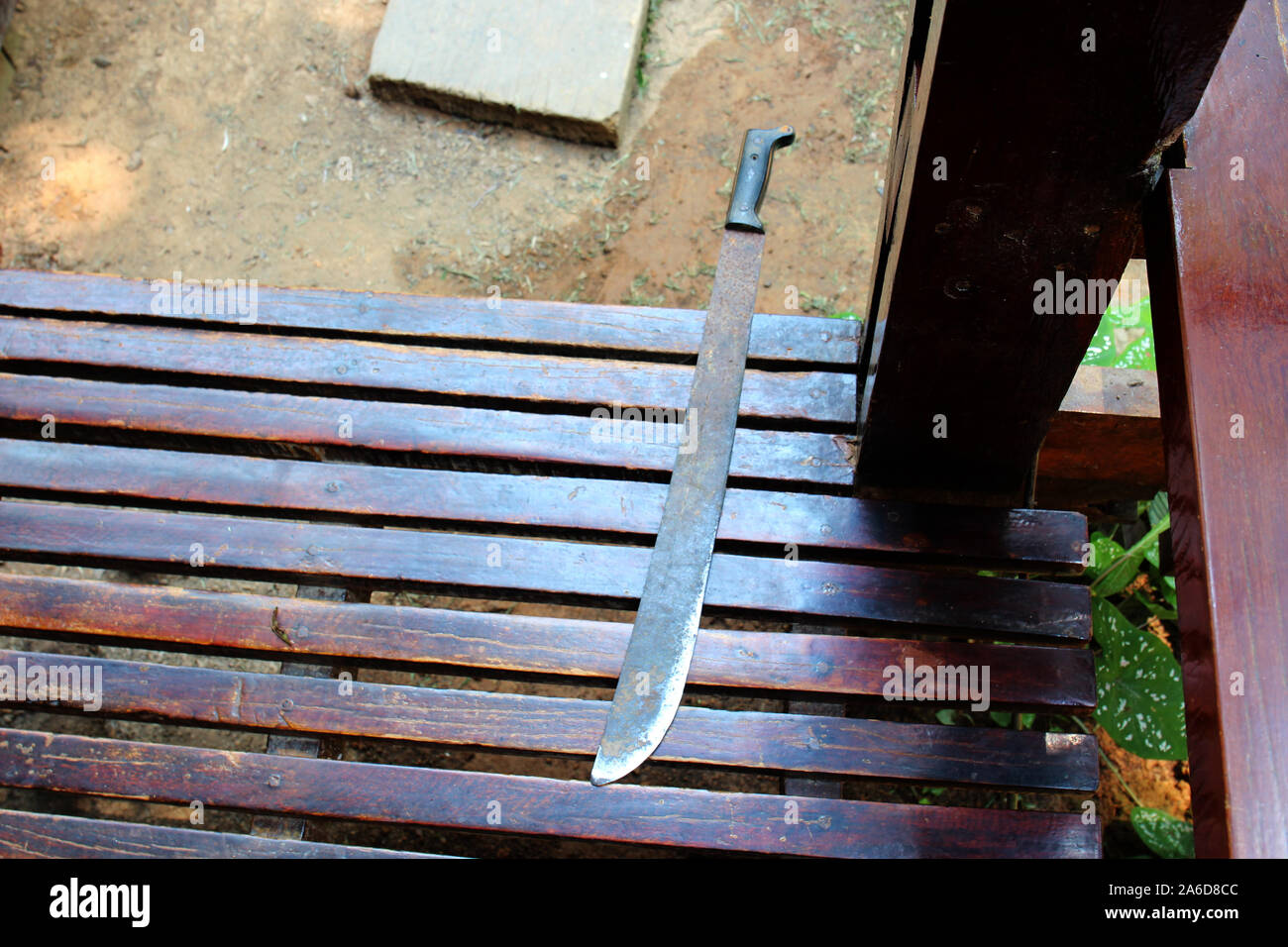 An old machete laying on a wood slat floor Stock Photo - Alamy