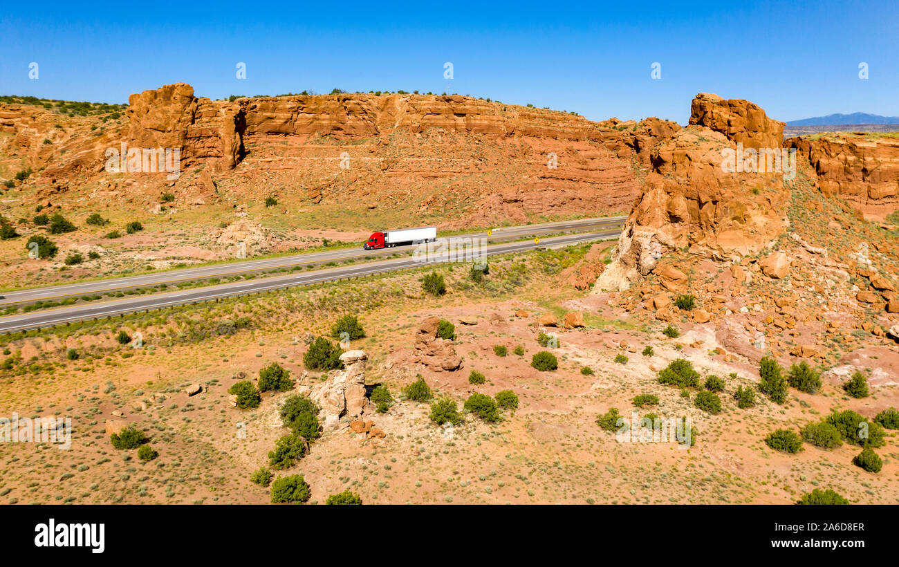 Big Rigs and vacation travelers drive along the highway in the desert ...