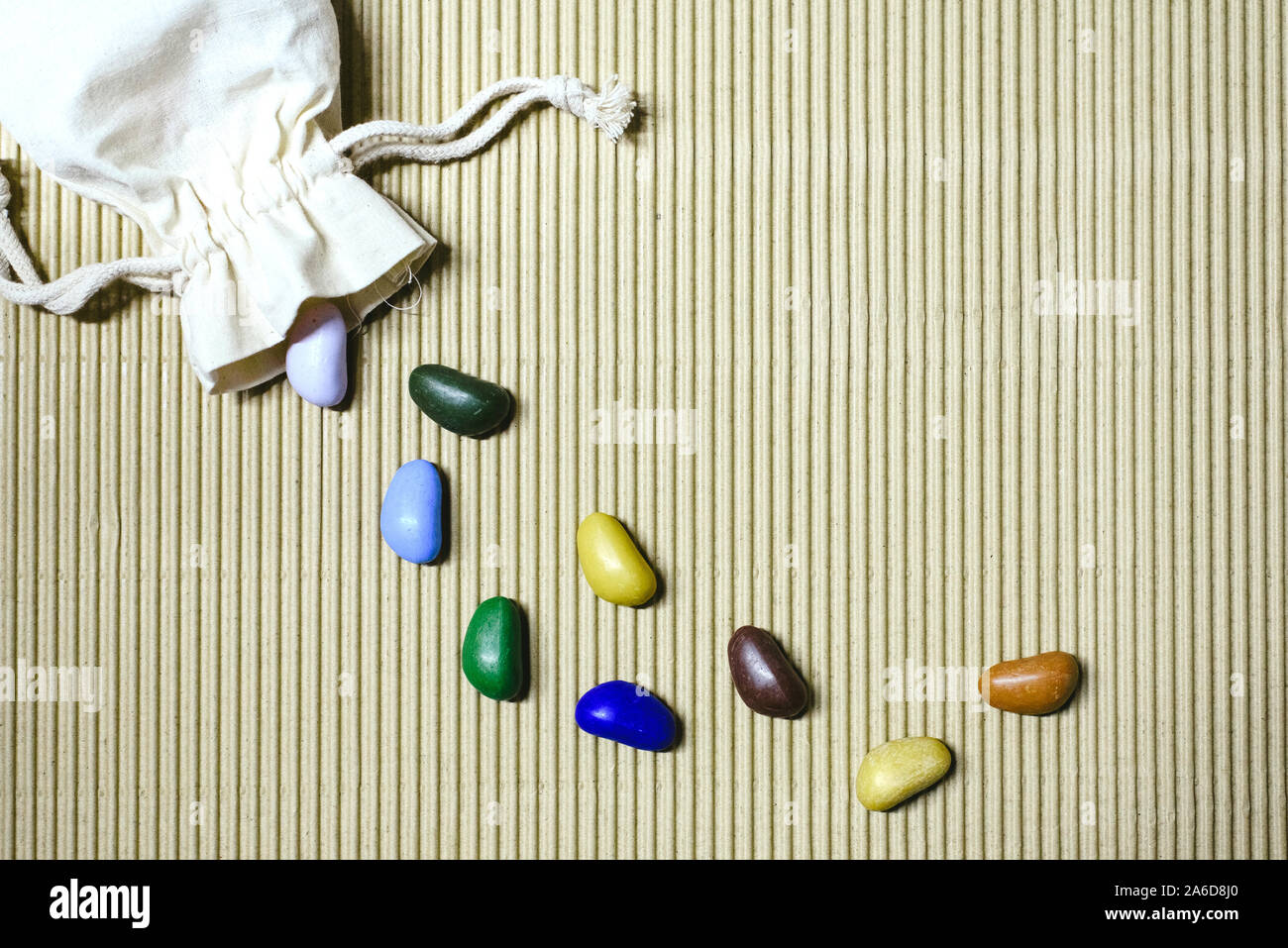 Background of colored fake stones scattered on a wavy paper with cloth ...